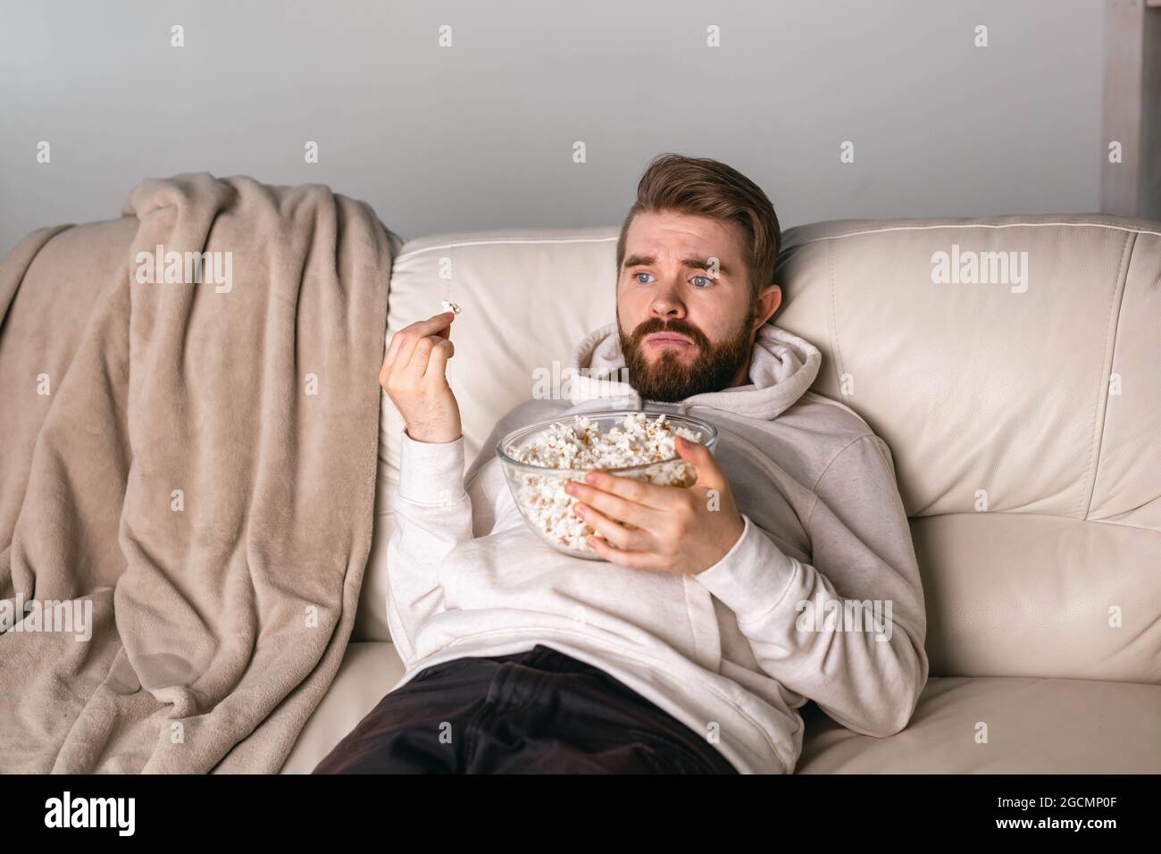 Portrait of guy watching TV series online. Online cinema and video ...