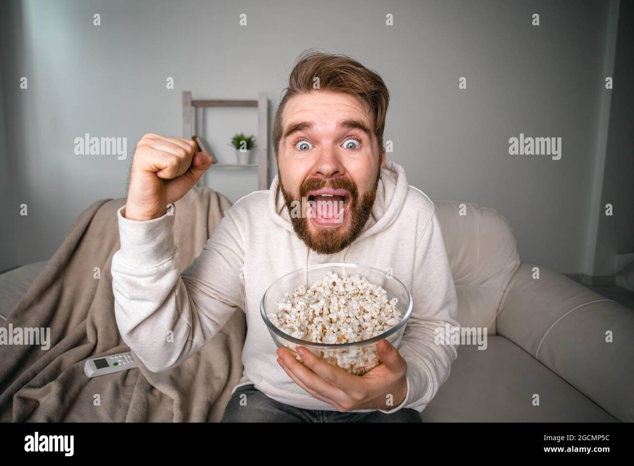 Happy guy watching TV series online. Online cinema and video streaming ...