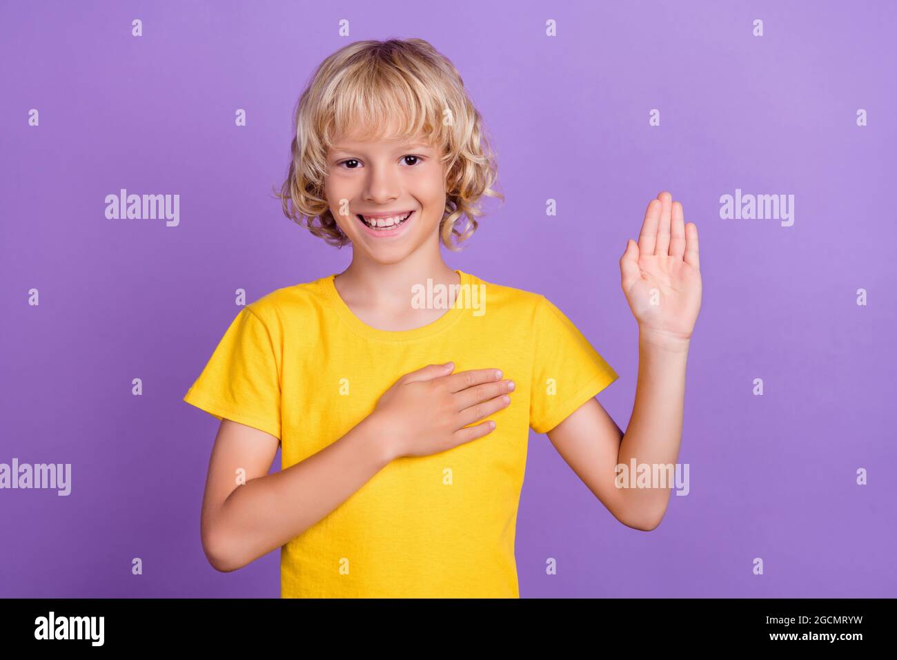 Photo of positive happy charming boy hold hand chest give oath pledge ...