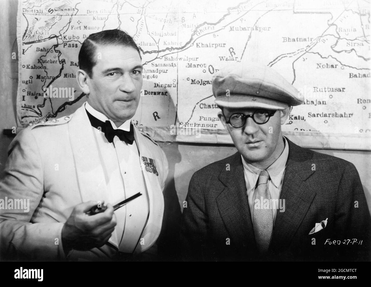 VICTOR McLAGLEN and Director JOHN FORD on set candid during filming of ...