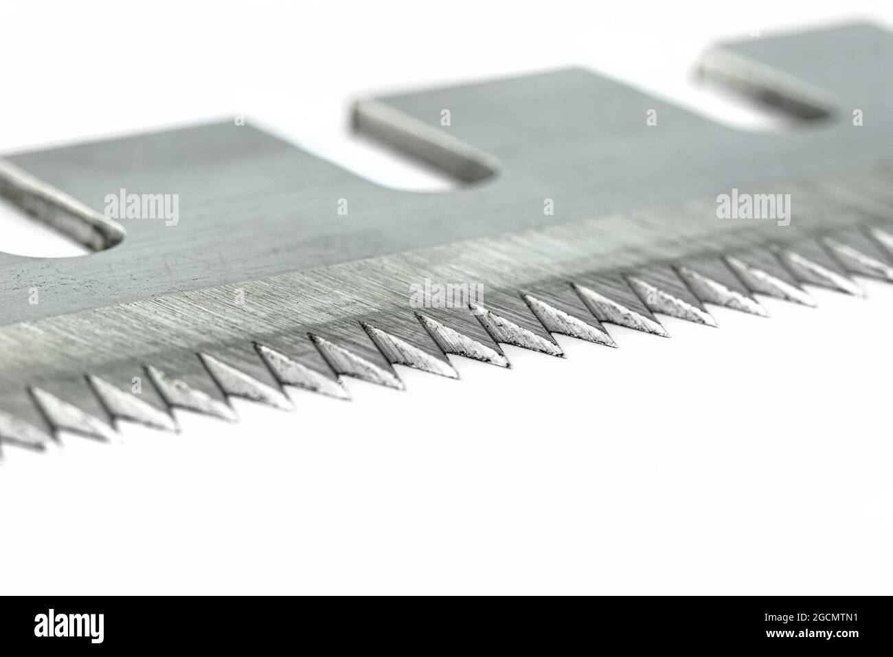 A macro photo of a serrated industrial blade for tape cutters, isolated ...