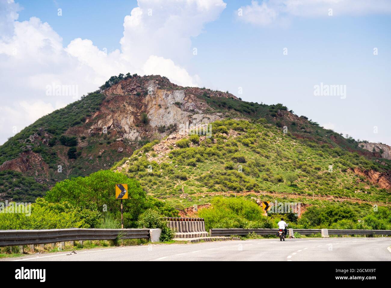 Wide shot of indian highway with trucks, cars, bikes, motorcycle and ...