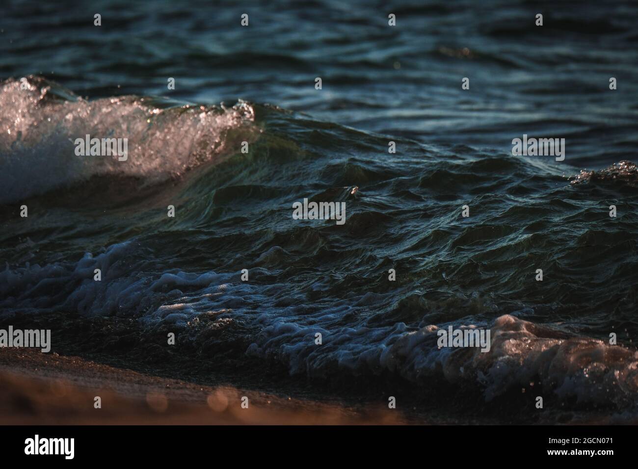 Closeup of an ocean wave with sunlight going through it Stock Photo - Alamy
