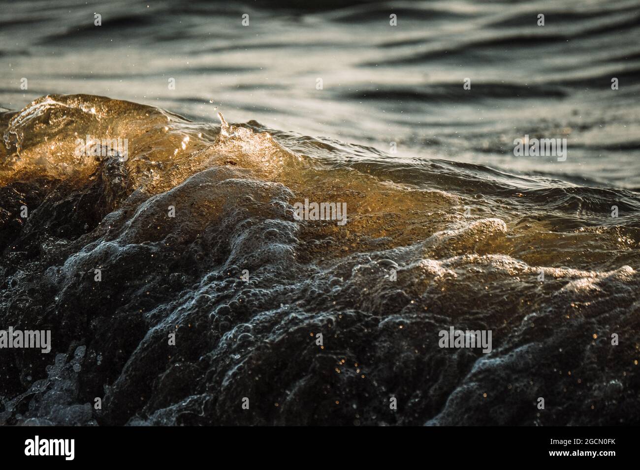 Closeup of an ocean wave with sunlight going through it Stock Photo - Alamy