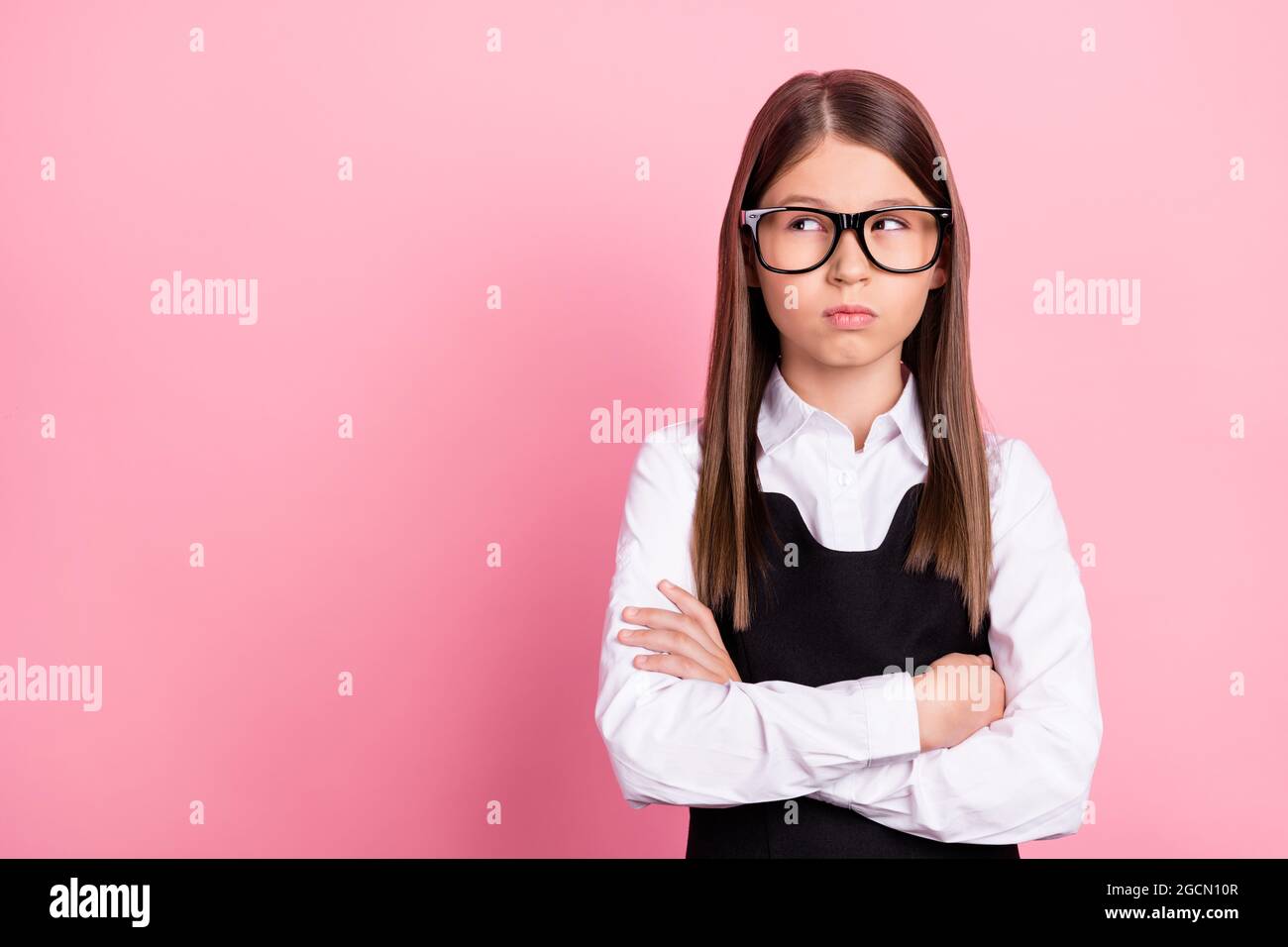 Photo of minded young small doubtful girl look empty space hold hand ...