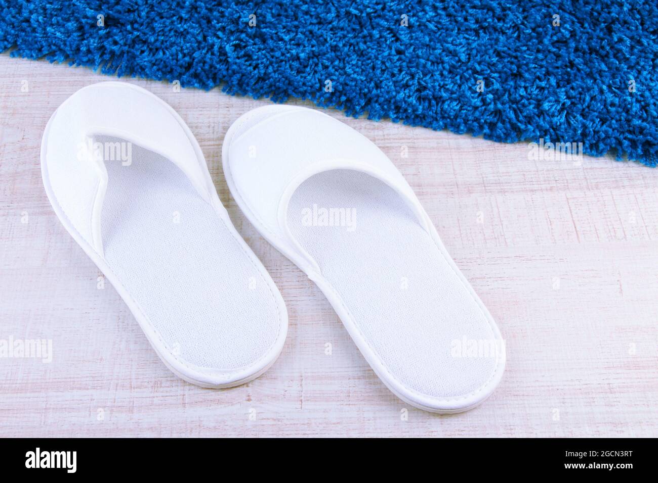 White slippers on floor background Stock Photo - Alamy