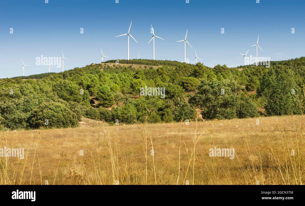 Modern windmills installed on hills in the countryside amidst ...