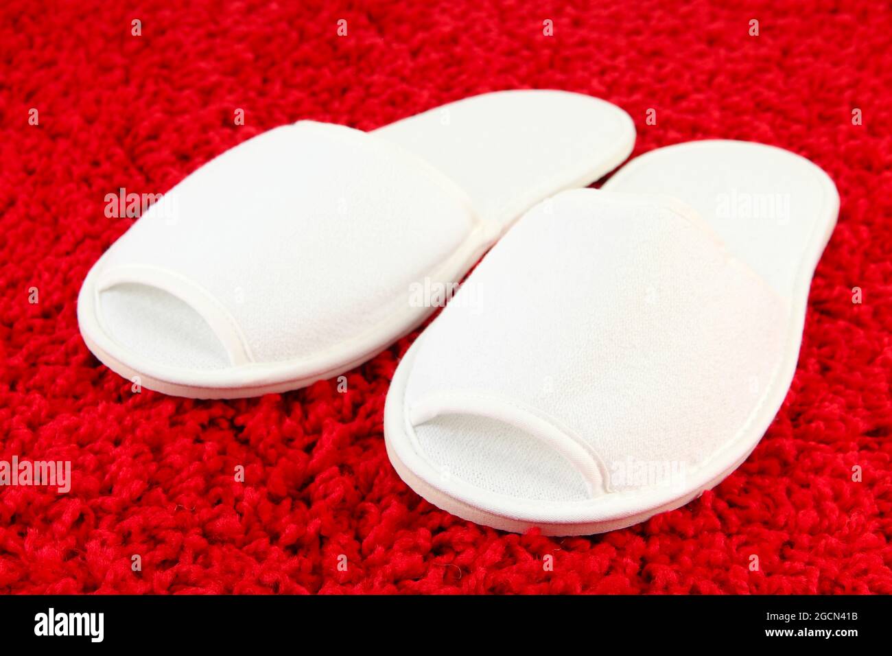 White slippers on carpet background Stock Photo - Alamy