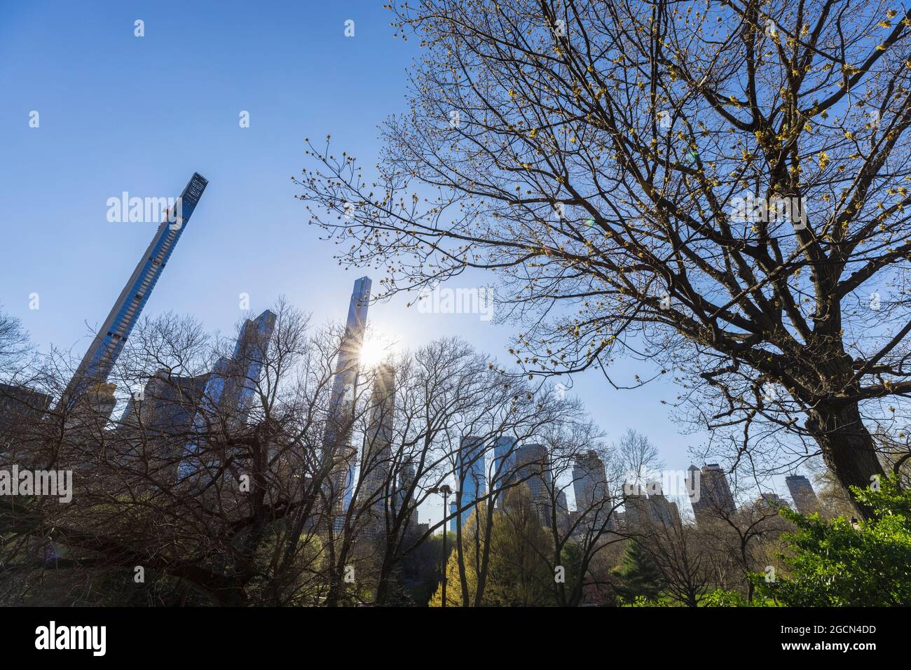 The sun shines from among Midtown Manhattan Skyscraper Central Park NYC ...