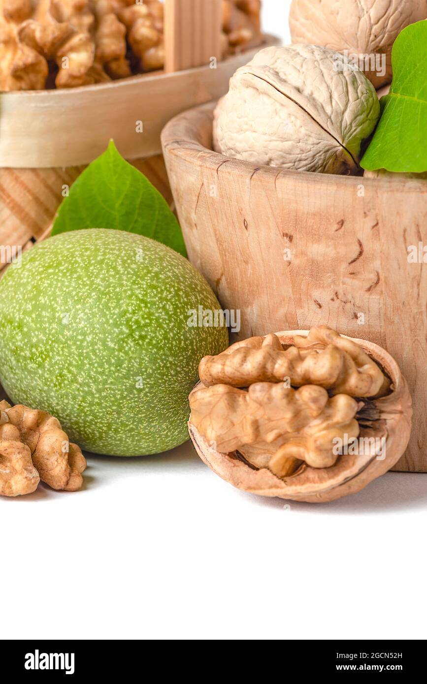 Walnut. Walnut fruits of different varieties lie in wooden saucers and ...