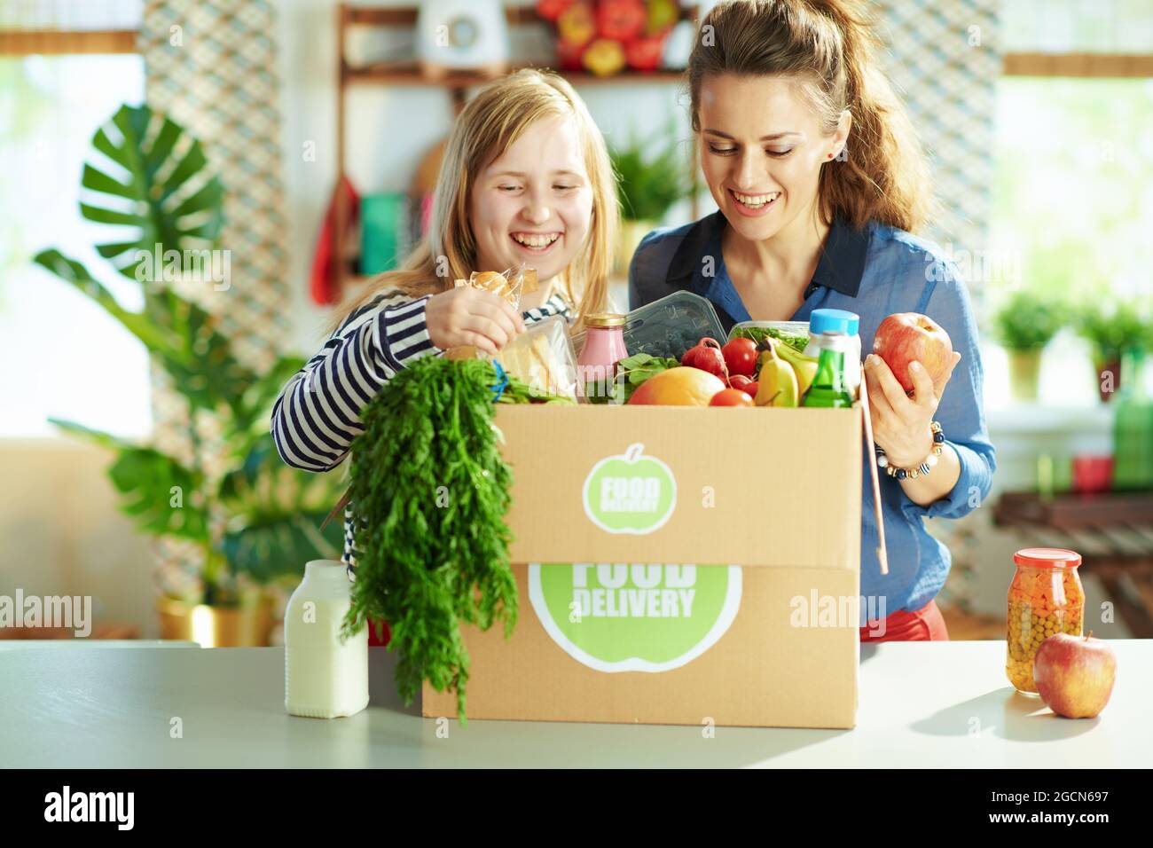 Food delivery. smiling young mother and child with food box in the ...