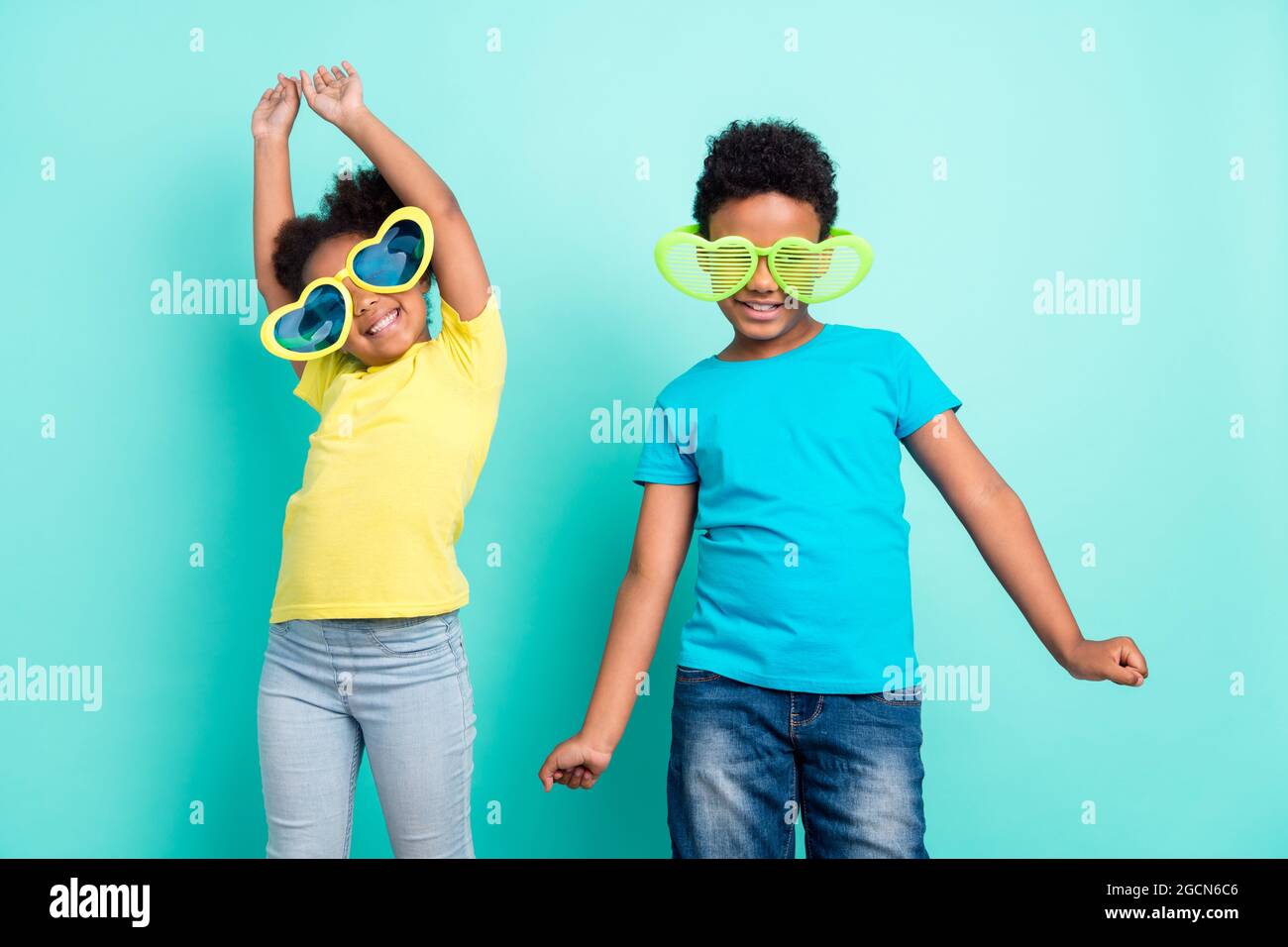 Portrait of two cheerful friends friendship wearing specs enjoying ...