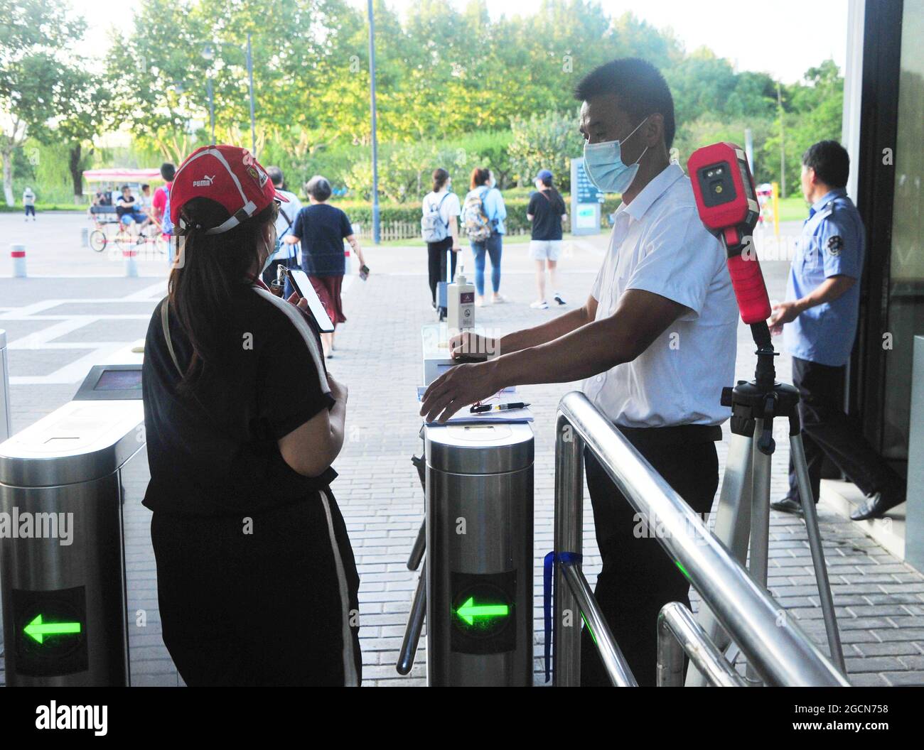 Staff check people's green health codes at the gate of the entrance in ...