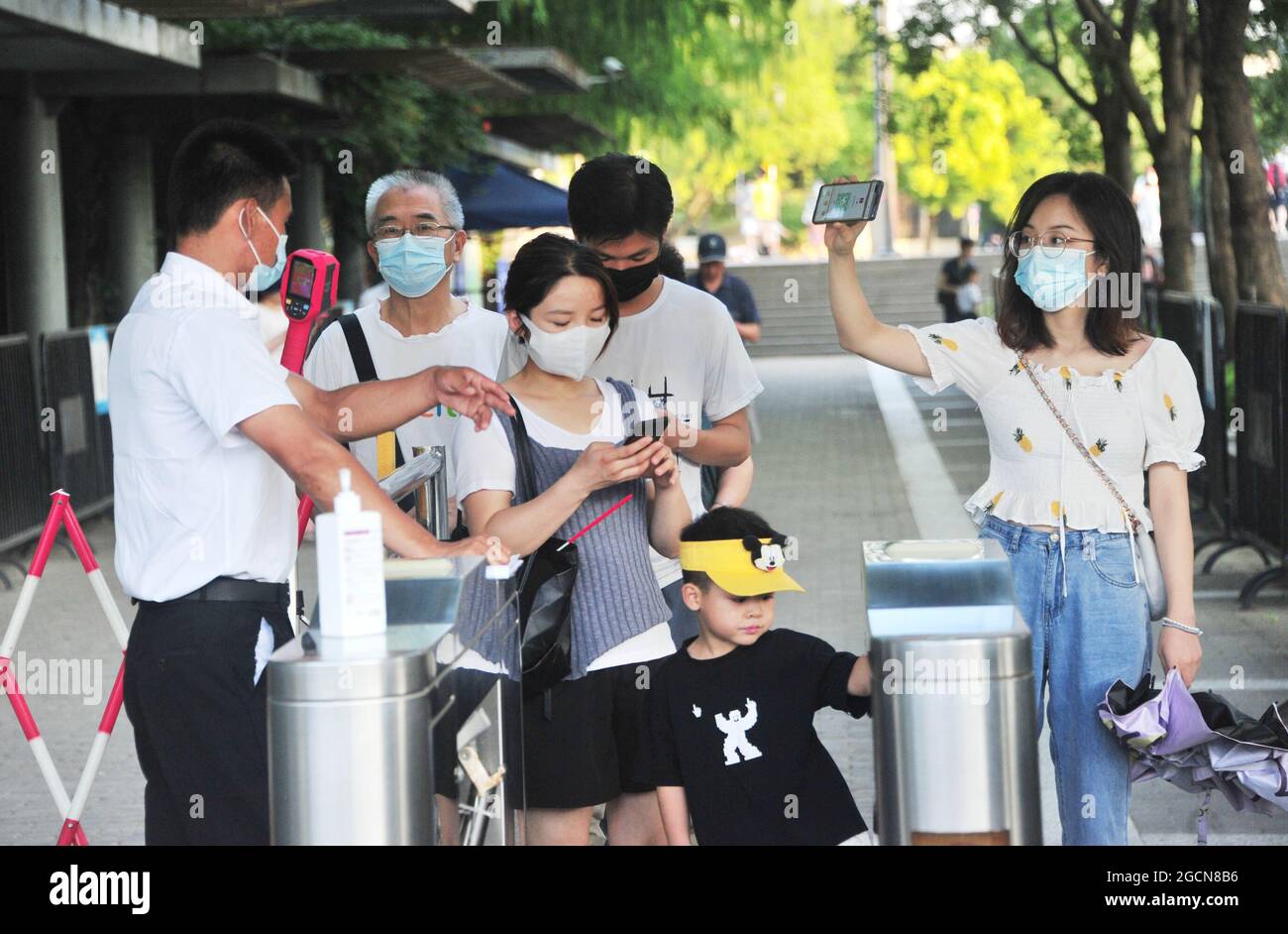 Staff check people's green health codes at the gate of the entrance in ...