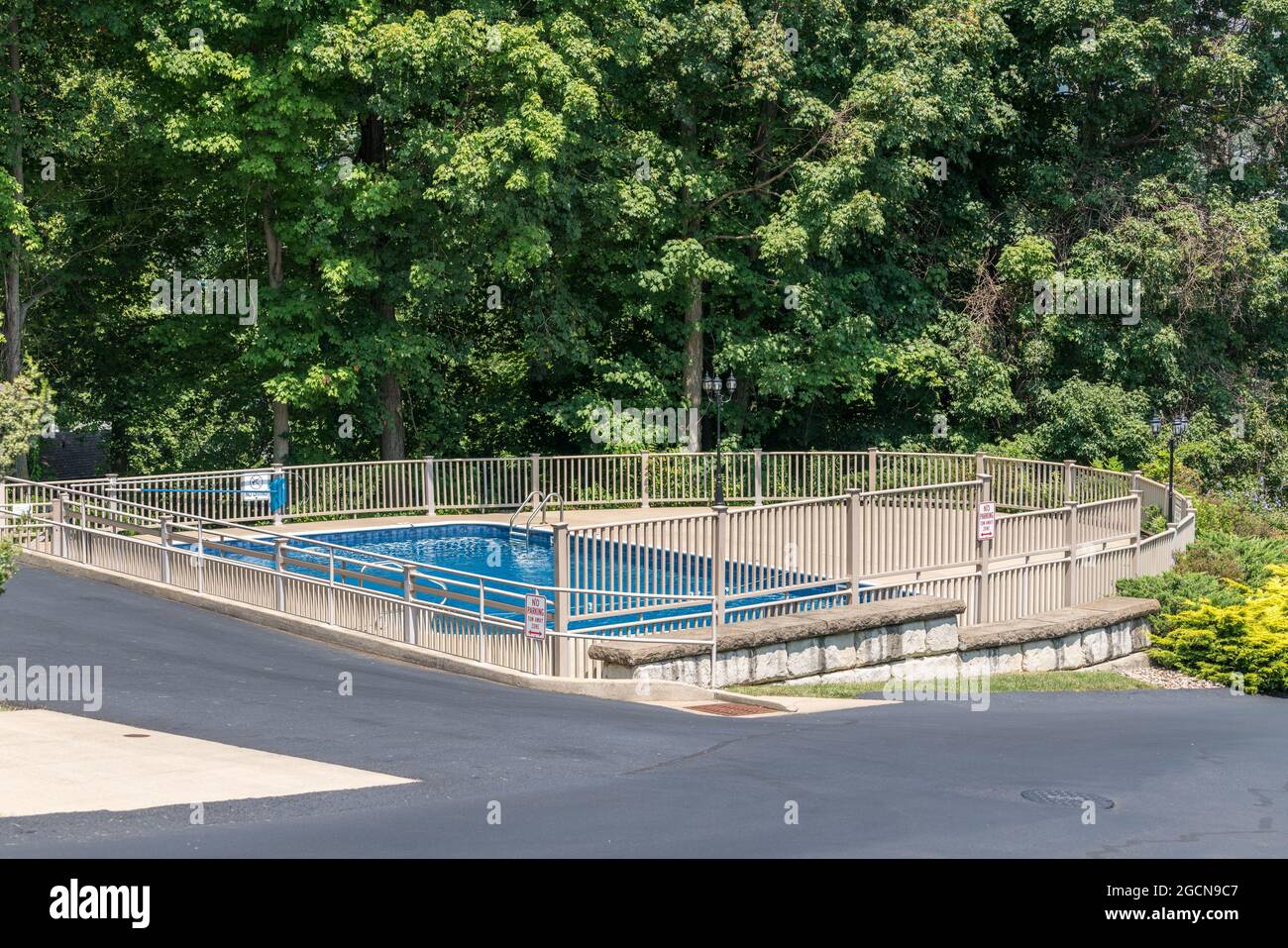 Small community swimming pool in summer behind security fence with no ...