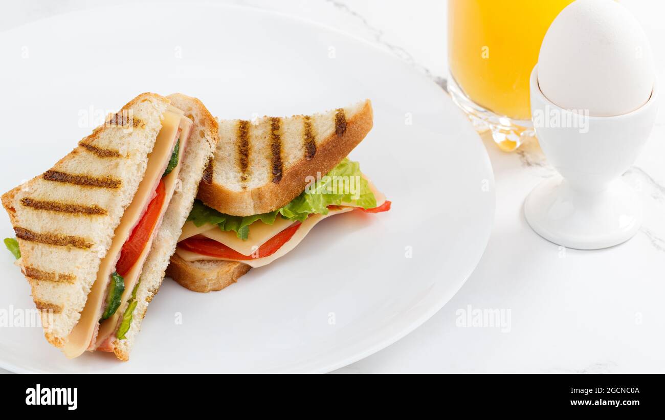 morning breakfast sandwich, boiled egg and orange juice Stock Photo - Alamy