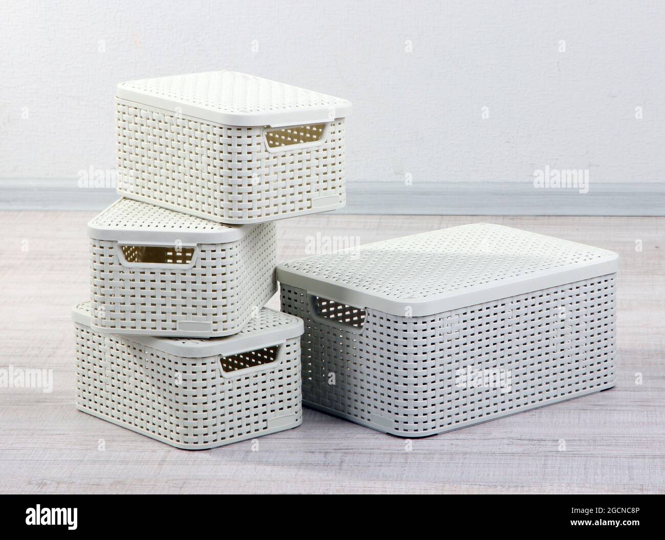 Plastic baskets for storing things in floor on room background Stock ...