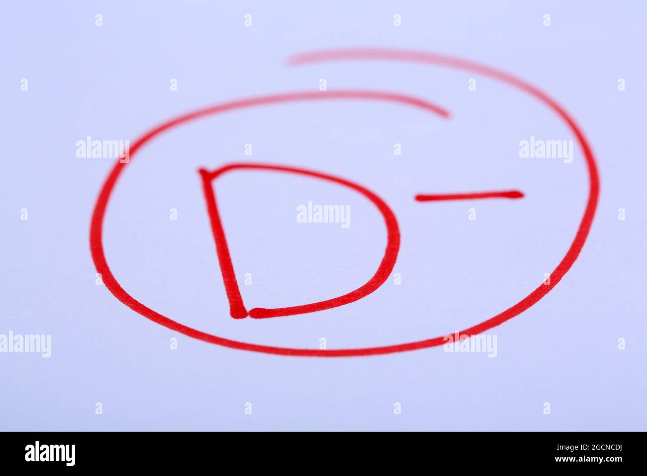 Grade D- written on an exam paper Stock Photo - Alamy