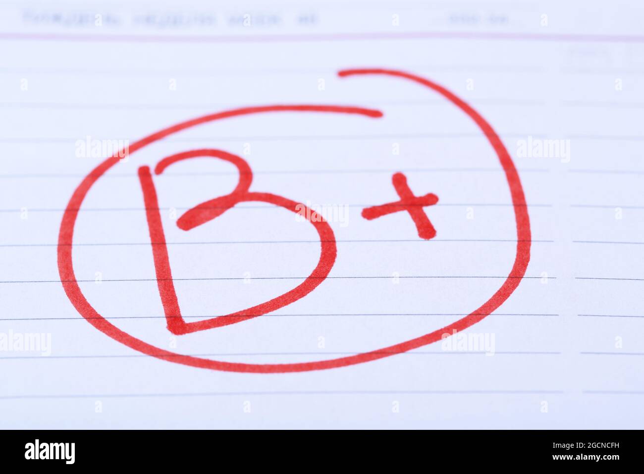 Grade B+ written on an exam paper Stock Photo - Alamy