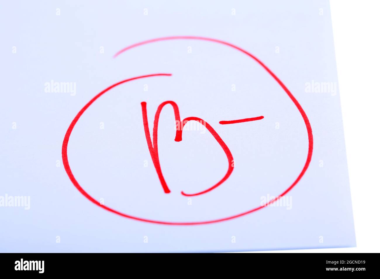 Grade B- written on an exam paper Stock Photo - Alamy