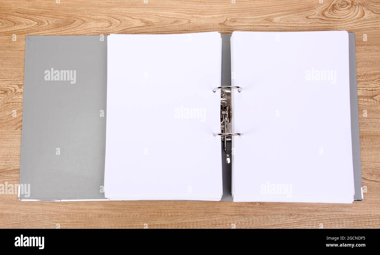 Open file folder on desk Stock Photo - Alamy