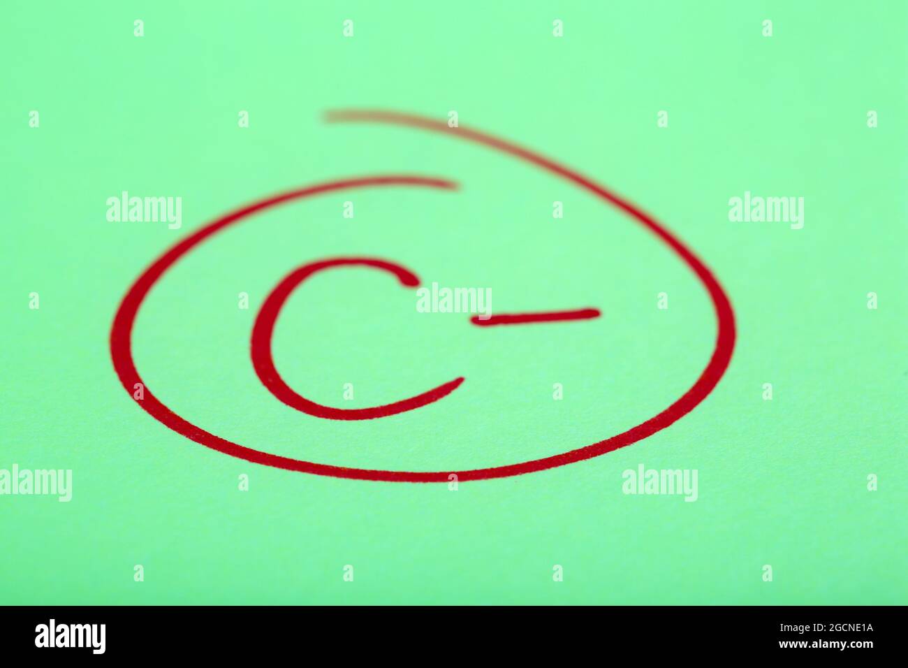 Grade C- written on an exam paper Stock Photo - Alamy