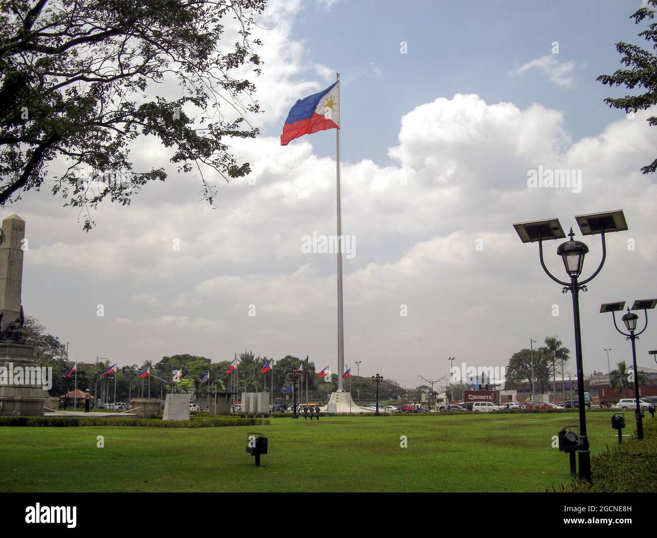 Filipino flag waves on a mast in the Rizal park in Manila on the ...