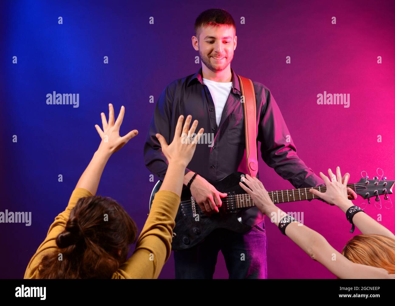 Guitarist singing on stage at a rock concert for his adoring fans Stock ...