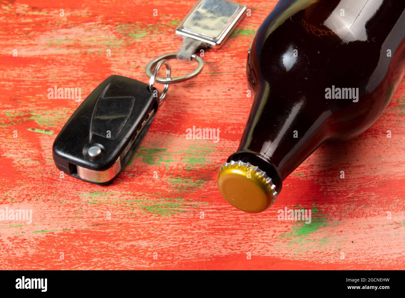 alcohol abuse and danger in car driving symbolized by key and bottle ...