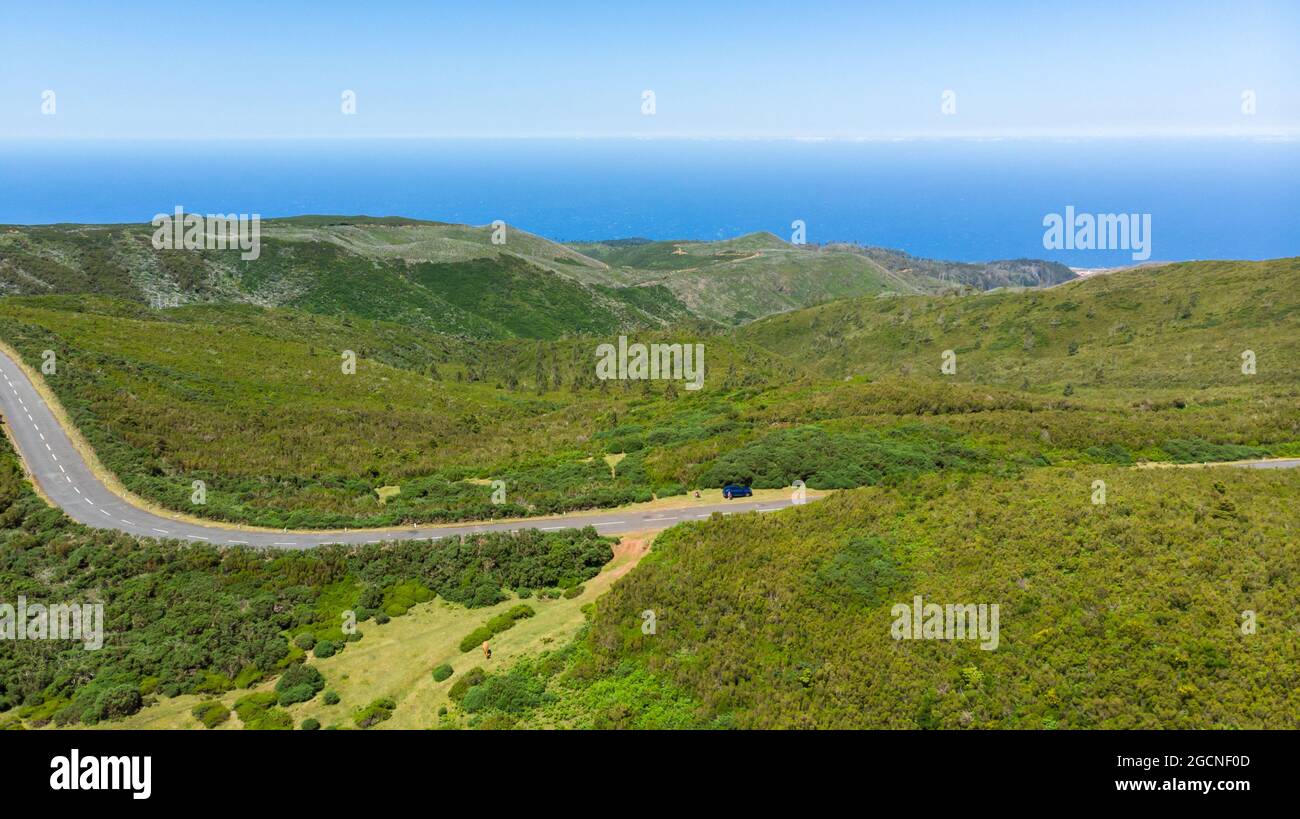 Aerial panorama of road crossing island ridge surrounded with lush ...