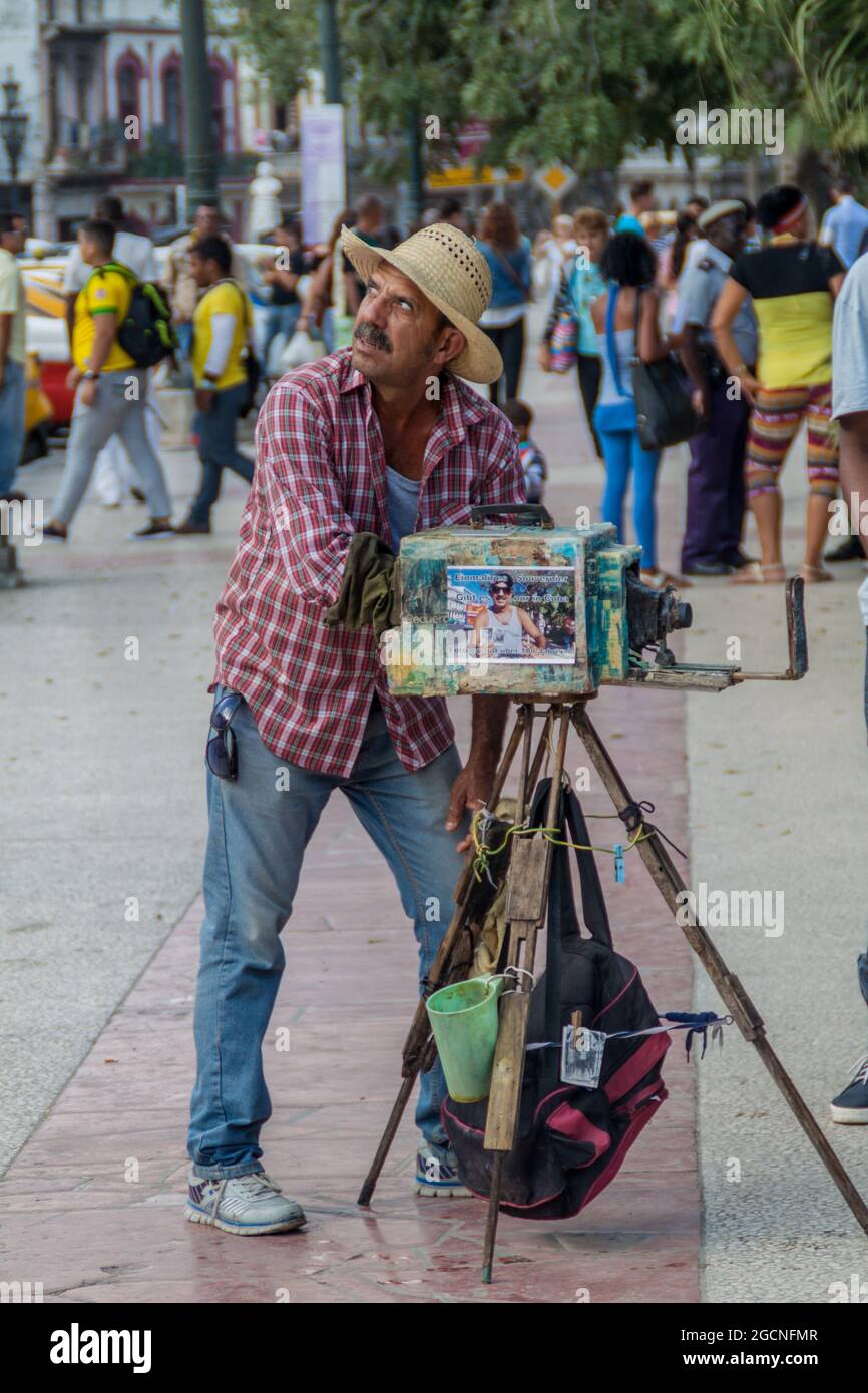 HAVANA, CUBA - FEB 20, 2016: Street photographer using a vintage camera ...