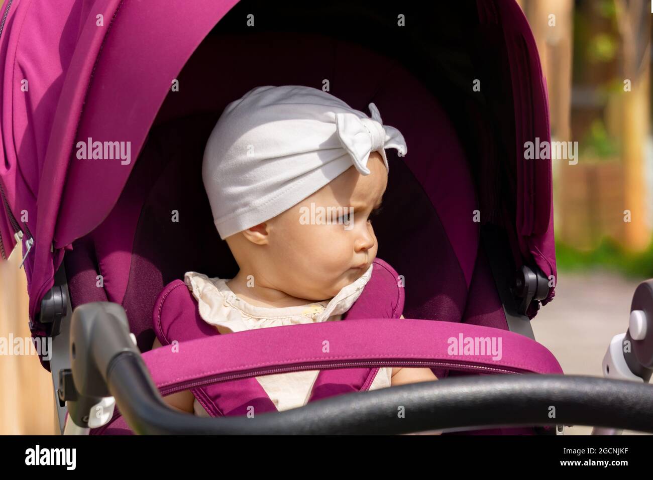 funny kid walking in a stroller is dissatisfied with something Stock ...