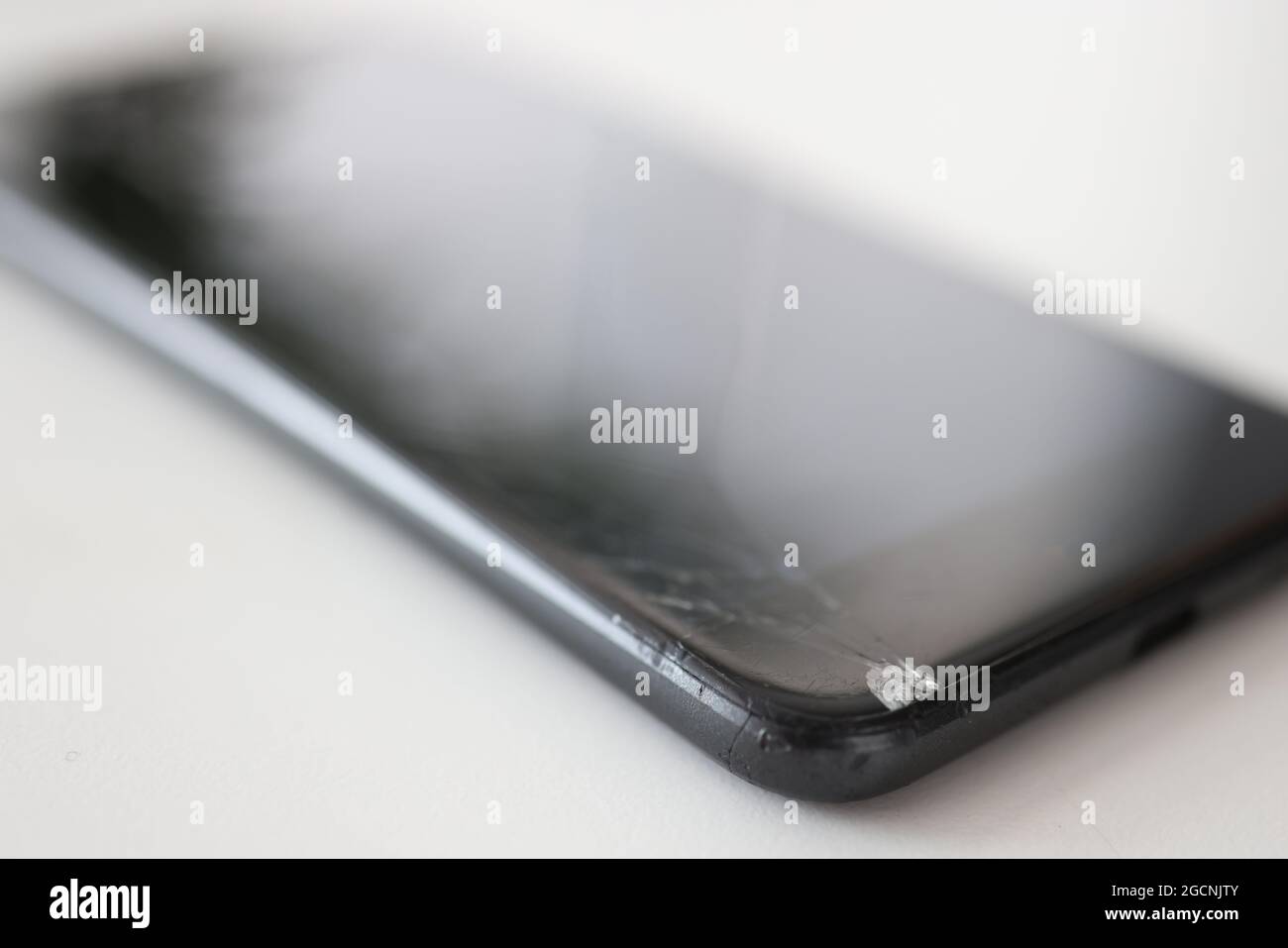 Smartphone with broken front screen is lying on table closeup Stock ...