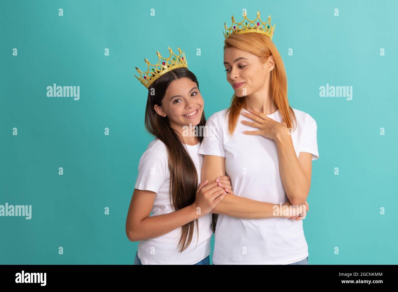 Selfish woman mother smile at happy girl child in crowns blue ...