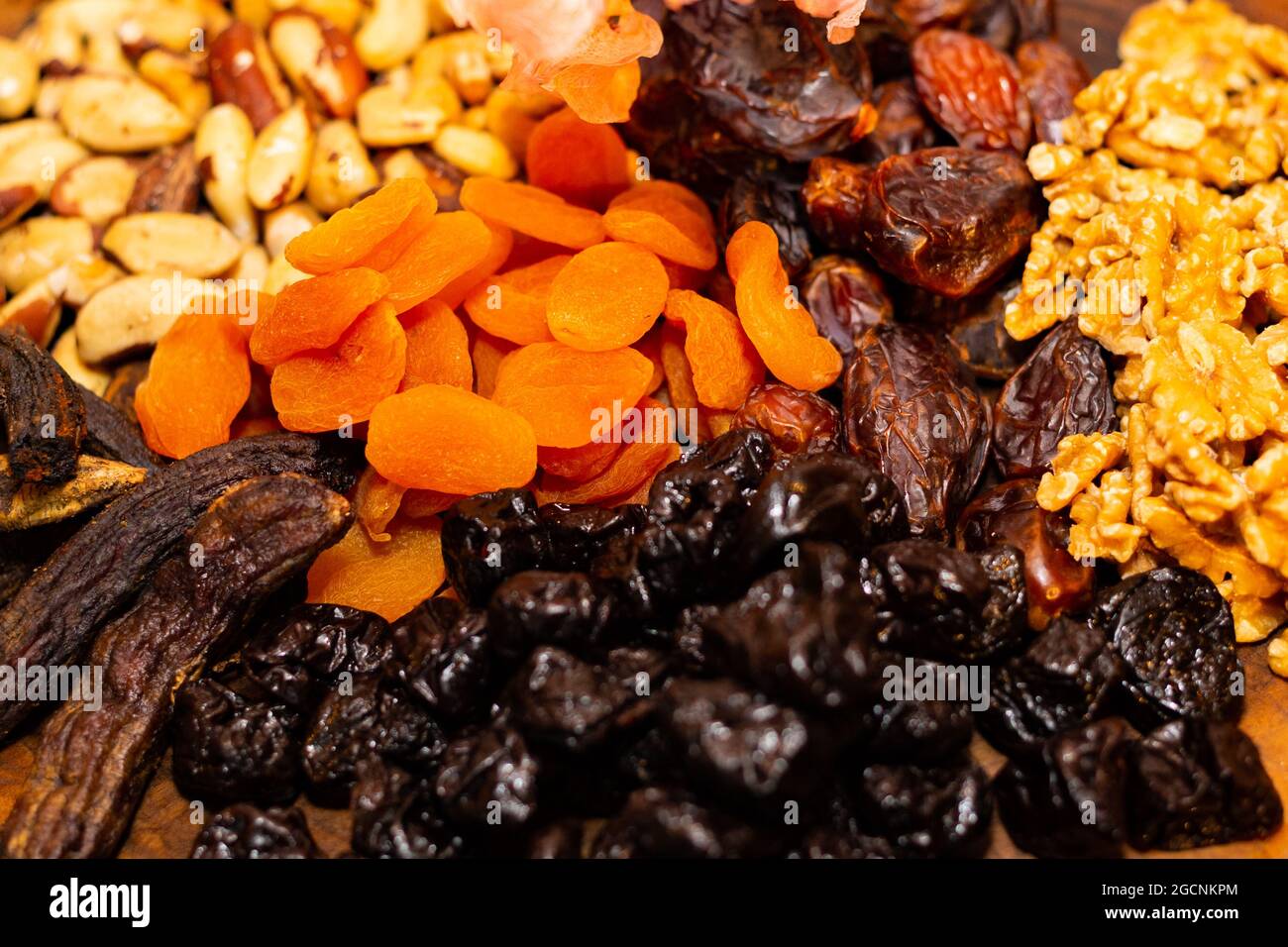A mix of dehydrated nuts and fruits, arranged, ready for consumption ...