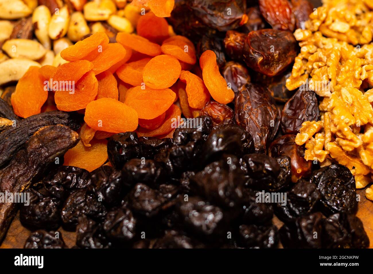 A mix of dehydrated nuts and fruits, arranged, ready for consumption ...