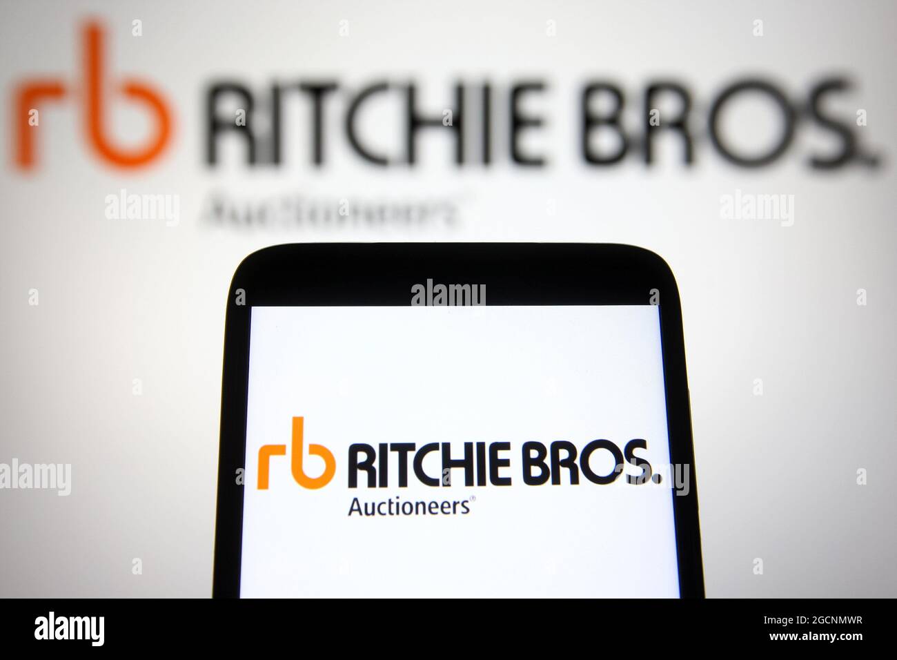 In this photo illustration a Ritchie Bros. Auctioneers (RBA) logo is ...