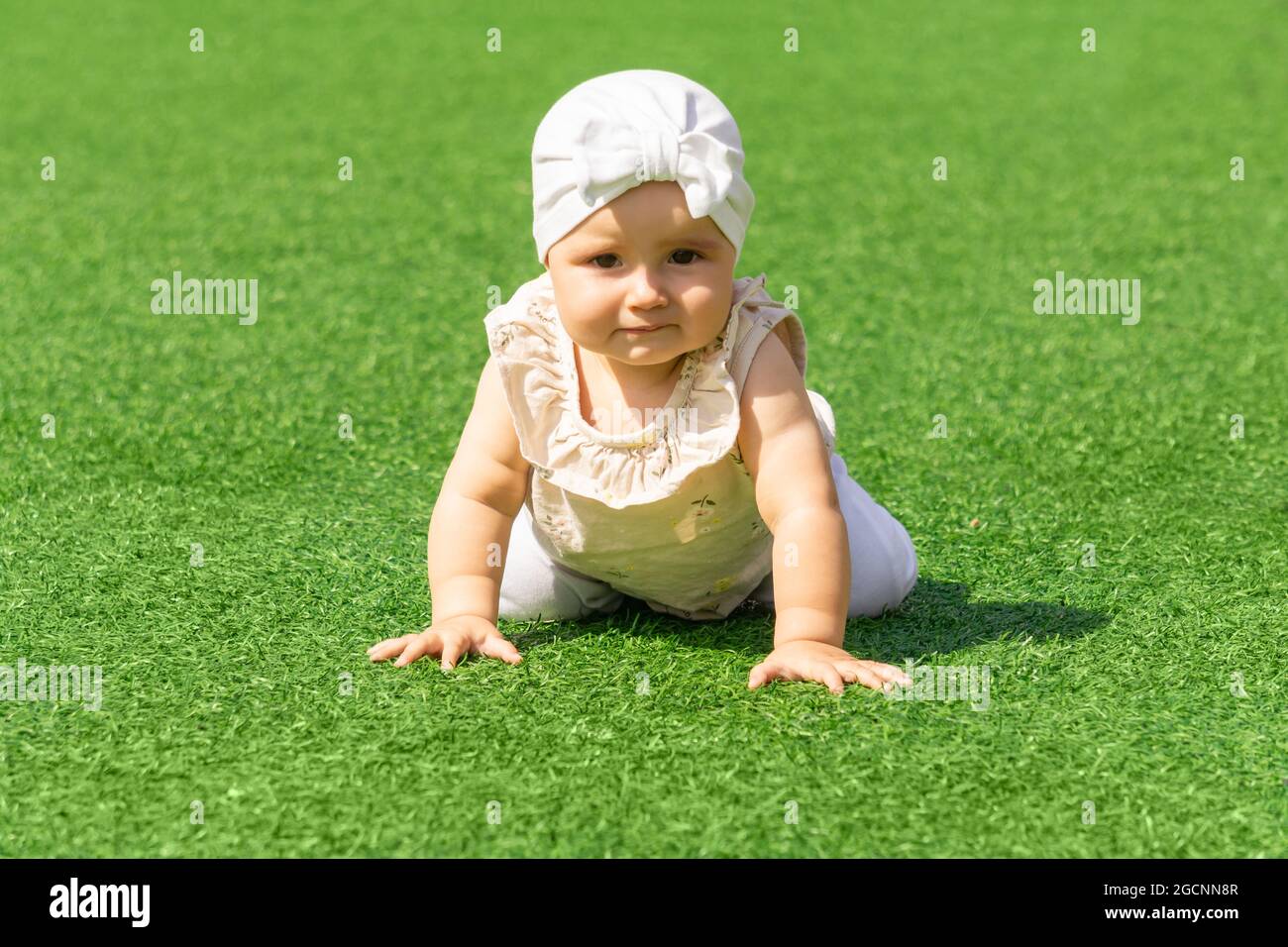 Baby girl crawling on grass hi-res stock photography and images - Alamy
