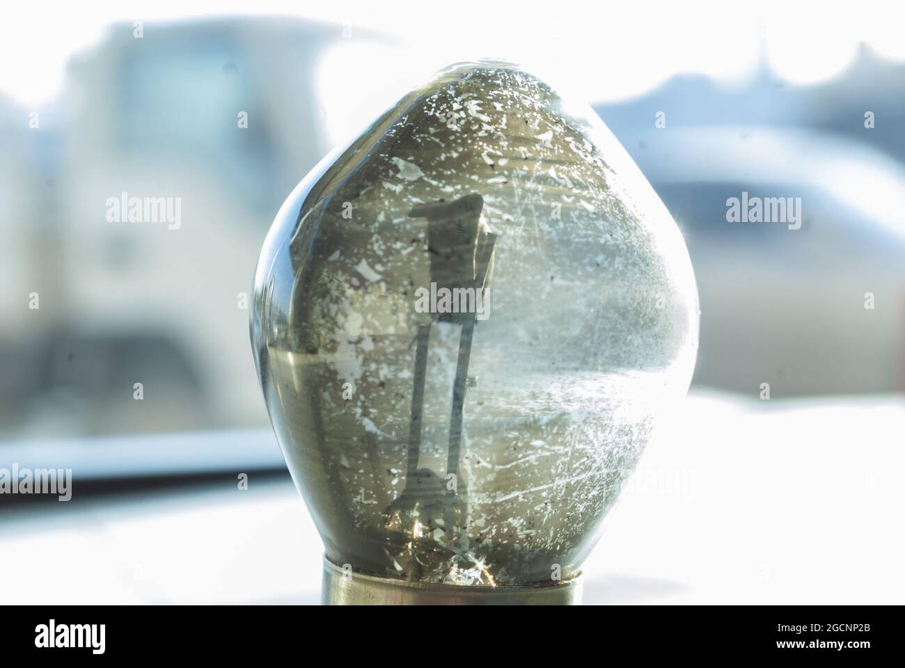 upright old dirty single transparent bulb closeup creative idea blurry ...