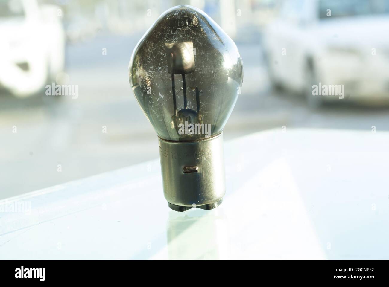 upright old dirty single transparent bulb closeup creative idea blurry ...