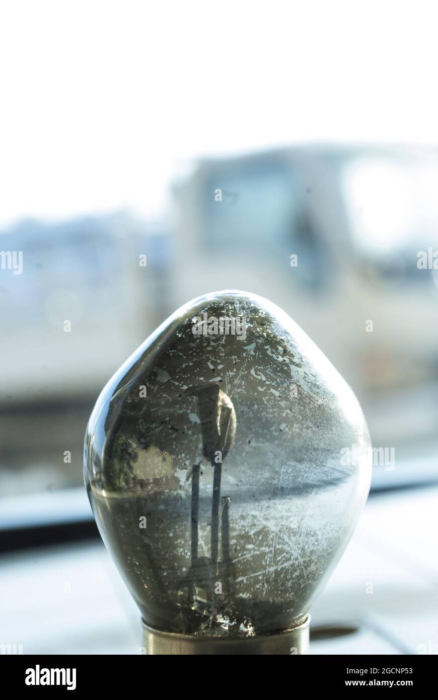 upright old dirty single transparent bulb closeup creative idea blurry ...