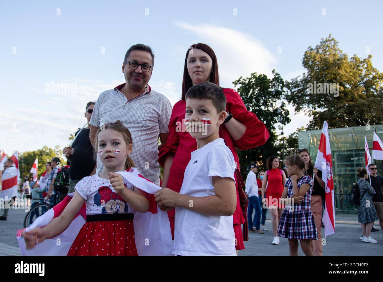 A family of Belarusians seen wearing red and whit, colours of the ...
