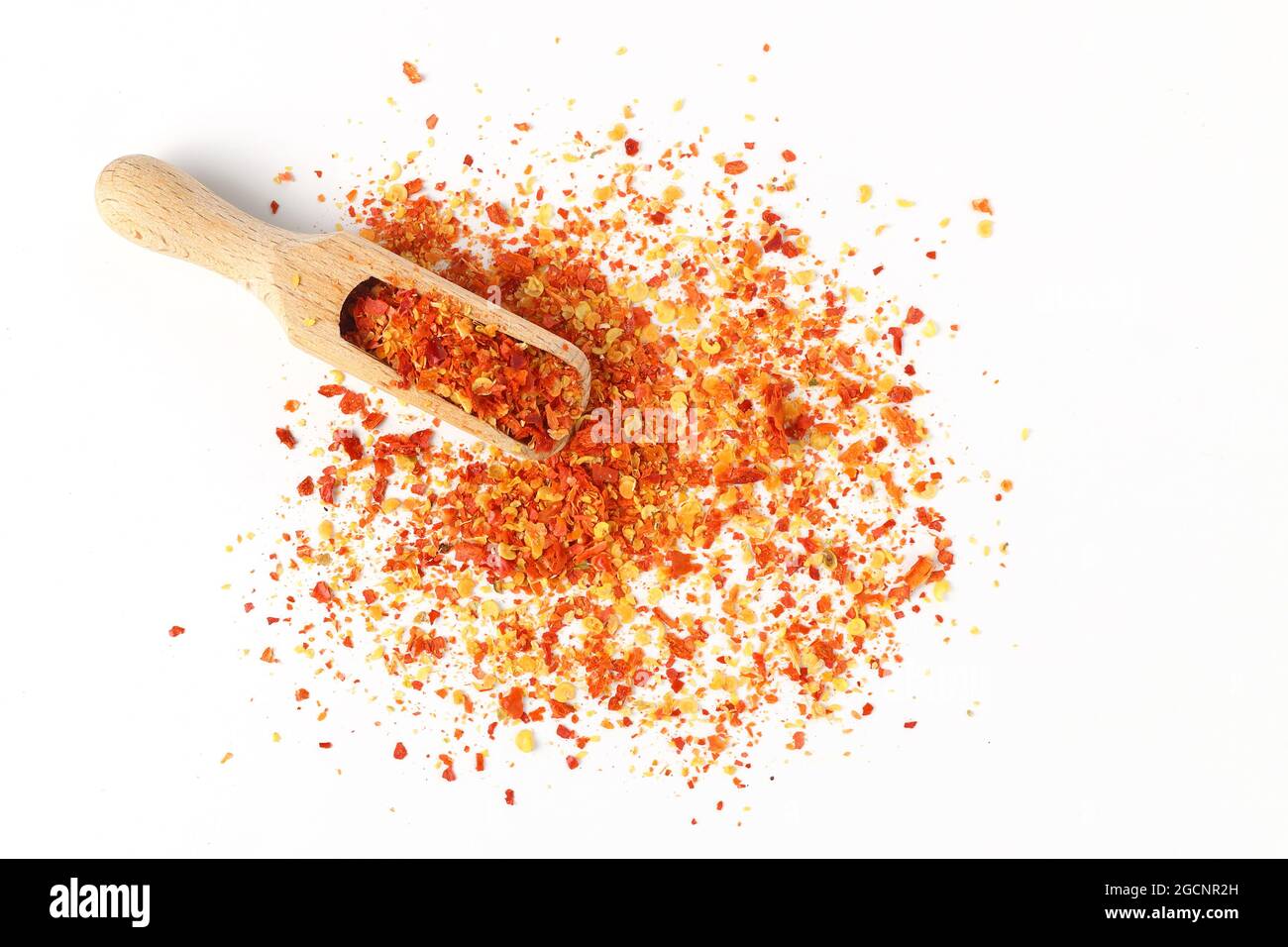 Dried red chili flakes in wooden spoon, isolated on white background ...