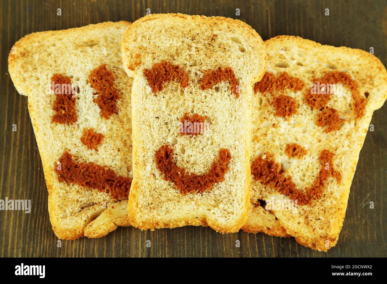 Funny toasts, on wooden background Stock Photo - Alamy