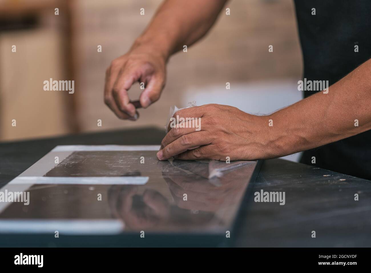 Hands removing the protective tape from a piece of furniture Stock ...