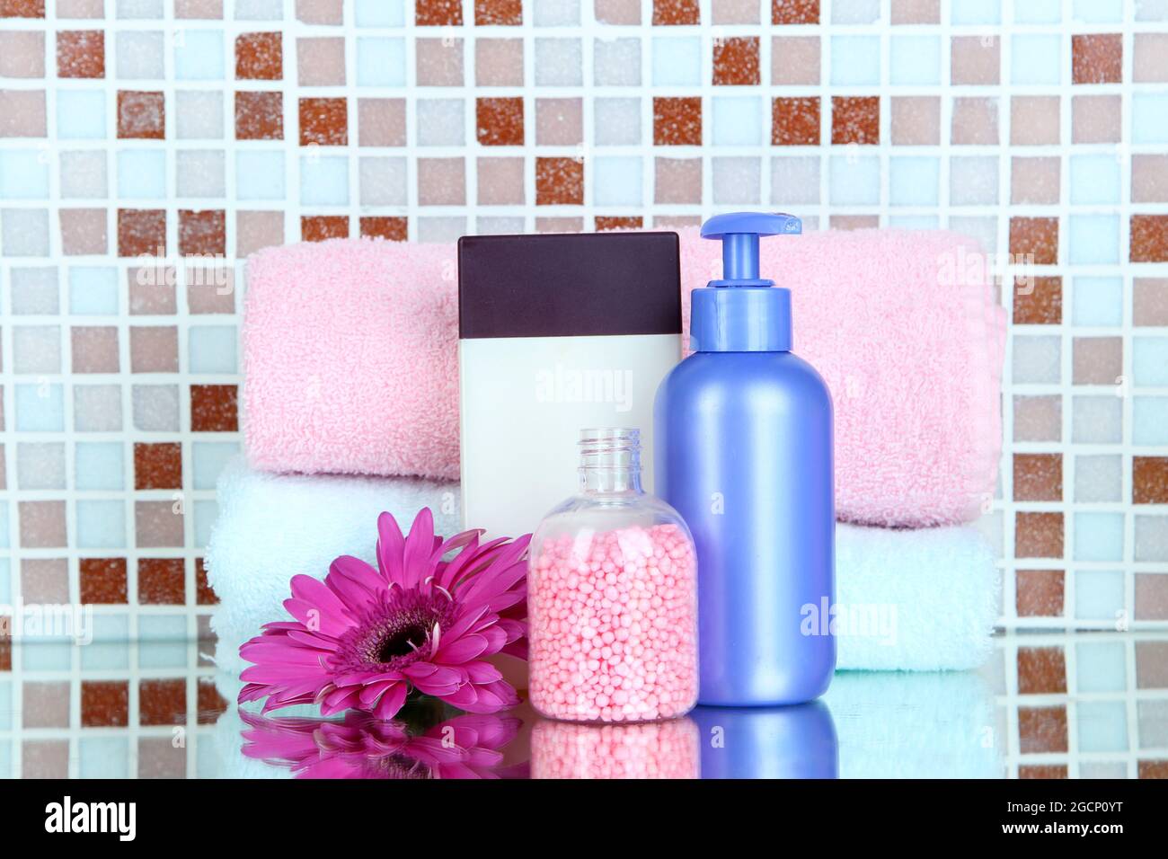 Cosmetics and bath accessories on mosaic tiles background Stock Photo ...