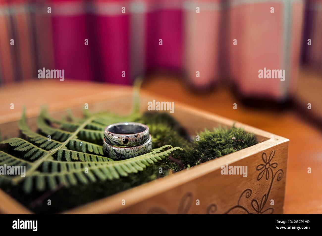 Wedding rings on green plant leaves Stock Photo - Alamy