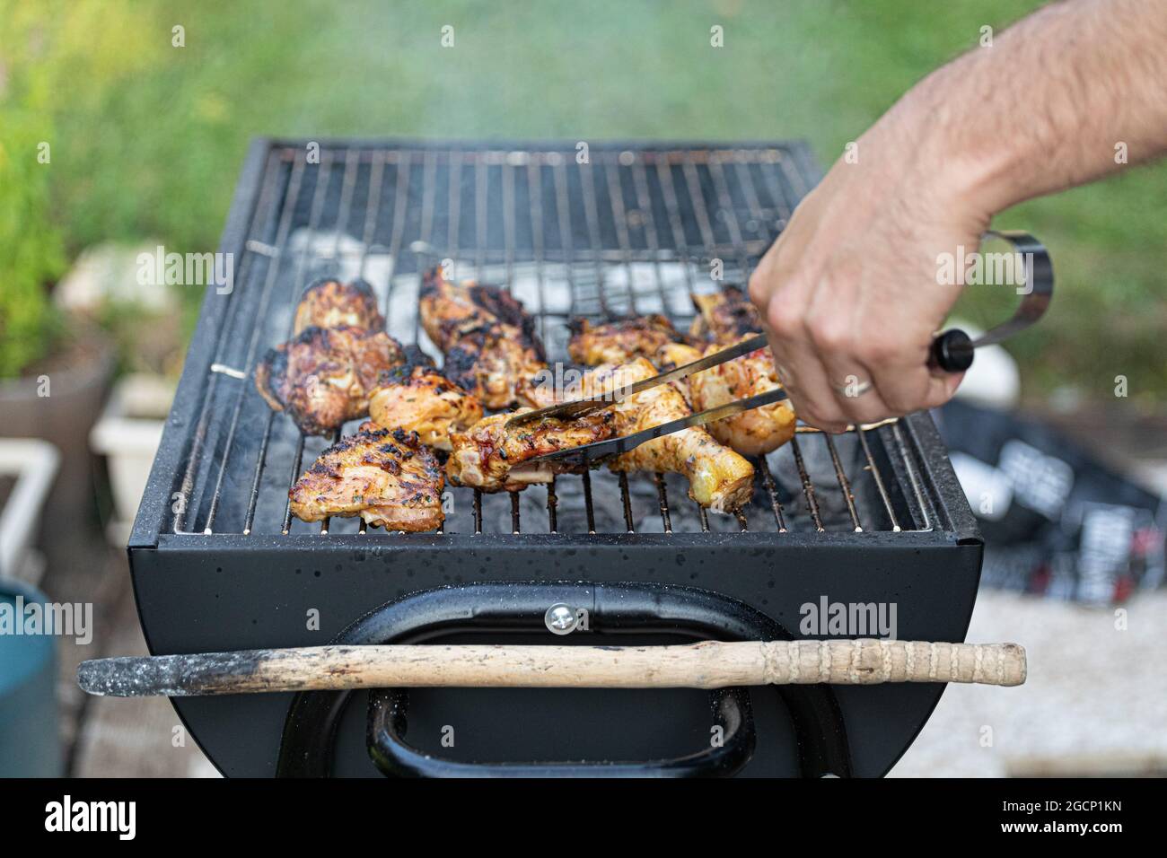 Barbecue on grill cooking hand hi-res stock photography and images - Alamy