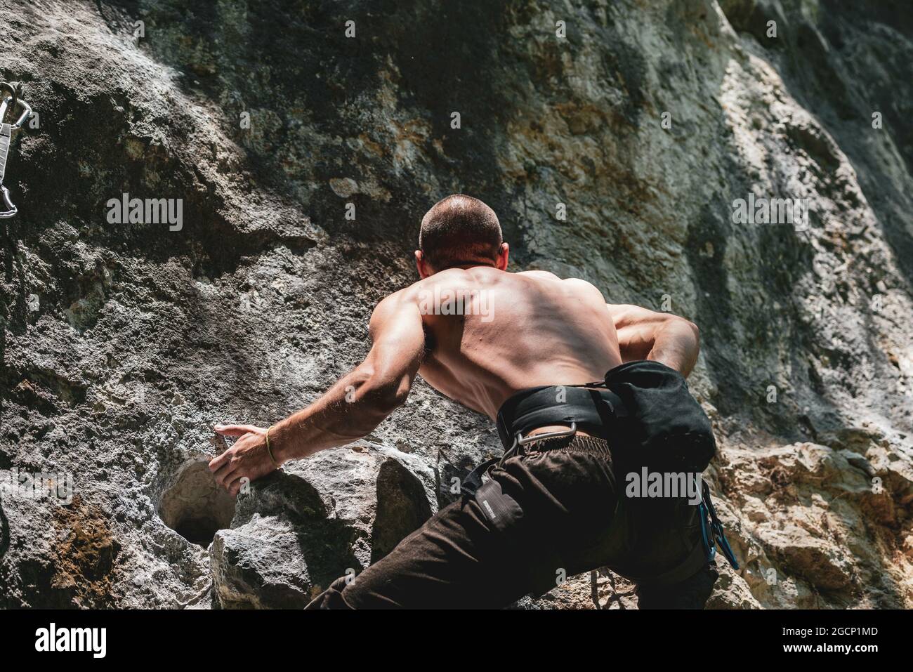 Man climbing up in the cave Stock Photo - Alamy