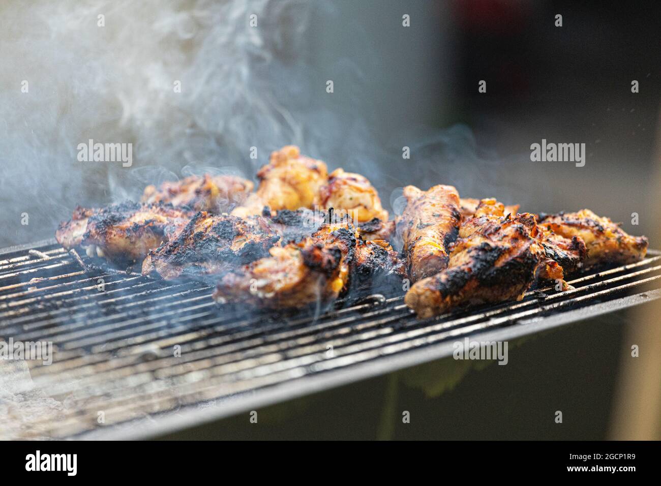 Chicken meat being cooked on a grill Stock Photo - Alamy